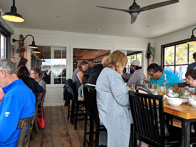 The dining room hums with the universal sound of seafood satisfaction&mdash;a chorus of "mmms" punctuated by the crack of crab shells.