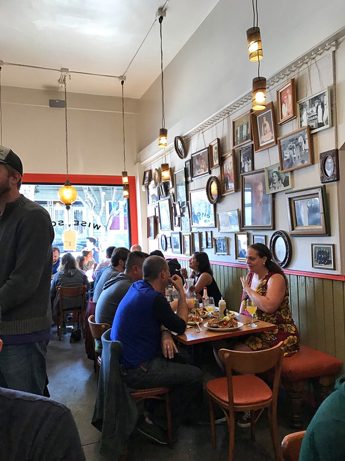 A bustling dining room where strangers become friends, united by the universal language of "mmm" and "pass the mustard."