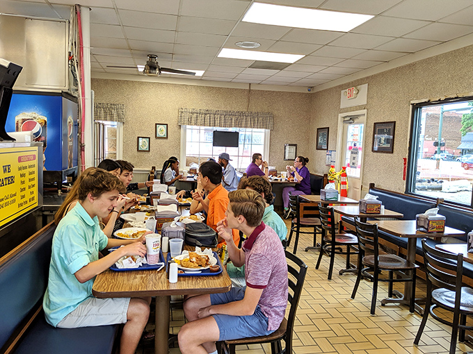 Families gathering around tables, proving that good chicken creates better conversations. No phones necessary when there's food this good.