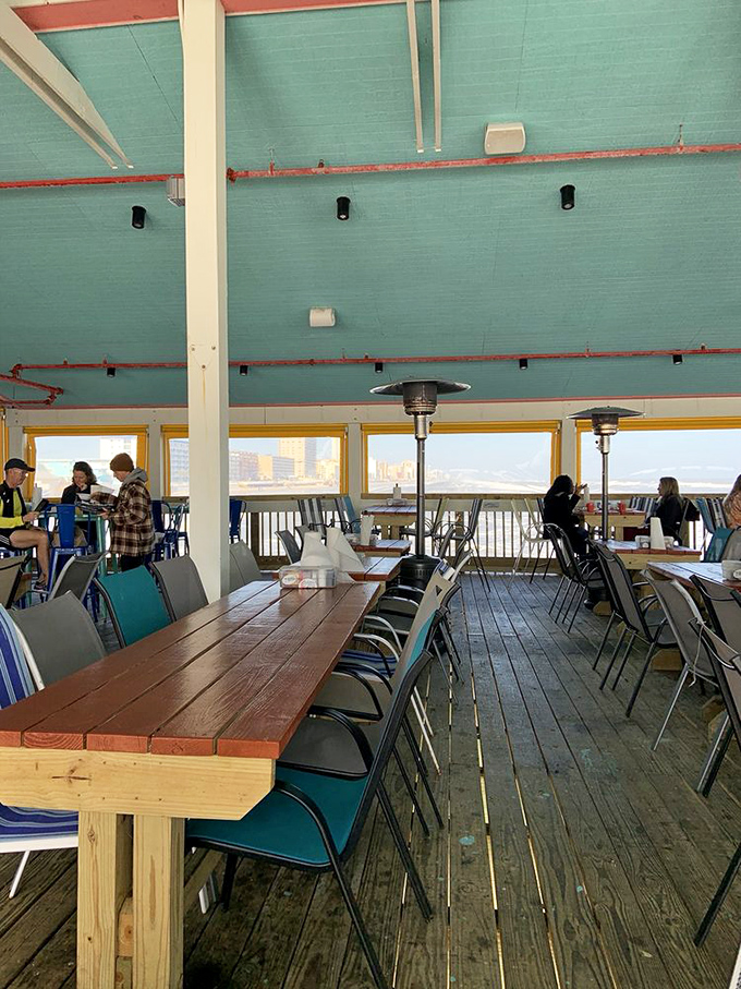 The turquoise ceiling matches the ocean view – a dining room where every table feels like the captain's table.