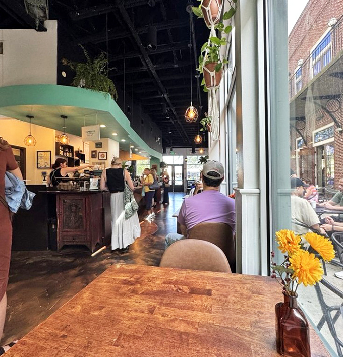 A sunflower in a bottle adds a touch of cheer to tables where conversations and coffee flow freely.