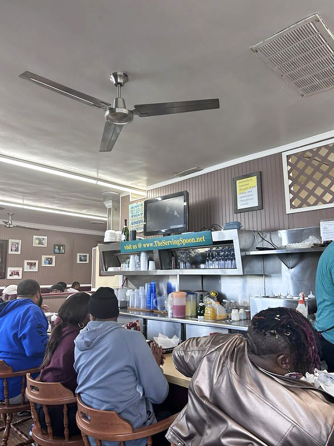 Counter seating offers front-row views of breakfast magic in action. The ceiling fans keep things cool while the griddle stays hot.