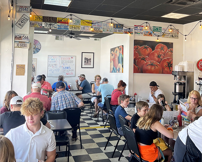 A full house on a busy morning. The license plates above watch over diners like automotive guardian angels of appetite.
