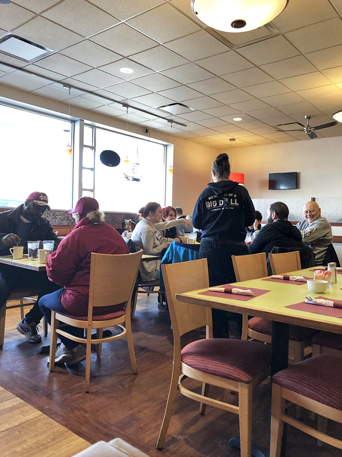 A bustling dining room where strangers become friends, united by the universal language of "pass the ketchup, please."