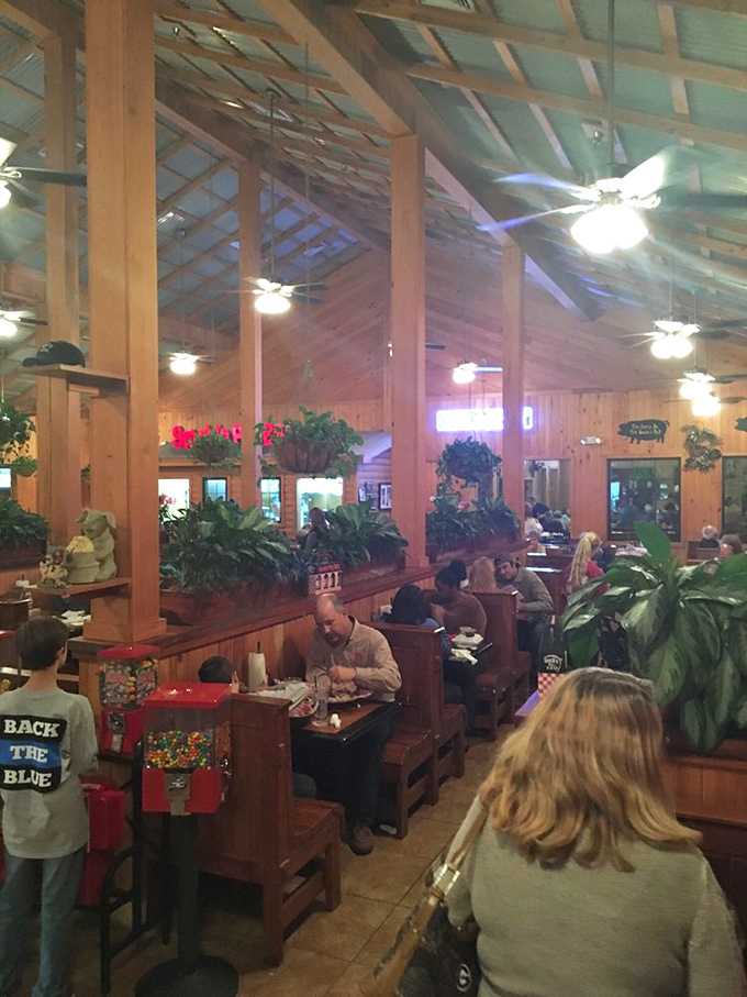 The dining room buzzes with the symphony of satisfied customers. Plants and wooden beams create the perfect setting for meat-induced joy.