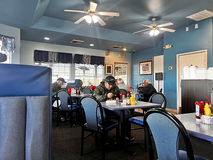 A symphony of satisfied diners performing the universal "good food quiet." Blue booths have witnessed countless breakfast epiphanies.
