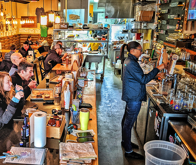 The beautiful dance of service: customers eagerly anticipating their orders while staff orchestrate the smooth delivery of smoky treasures.