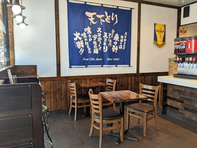 The blue noren curtain with Japanese characters adds authentic charm to the simple dining area. Every seat offers equal access to fried chicken nirvana.