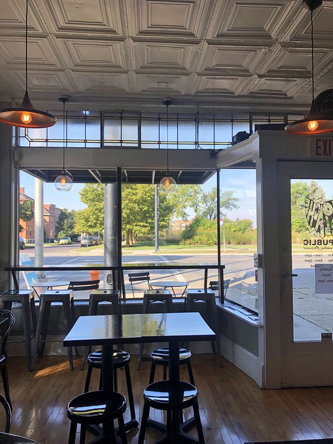 Sunlight streams through windows illuminating the minimalist dining area, where every table feels like the best seat in the house.
