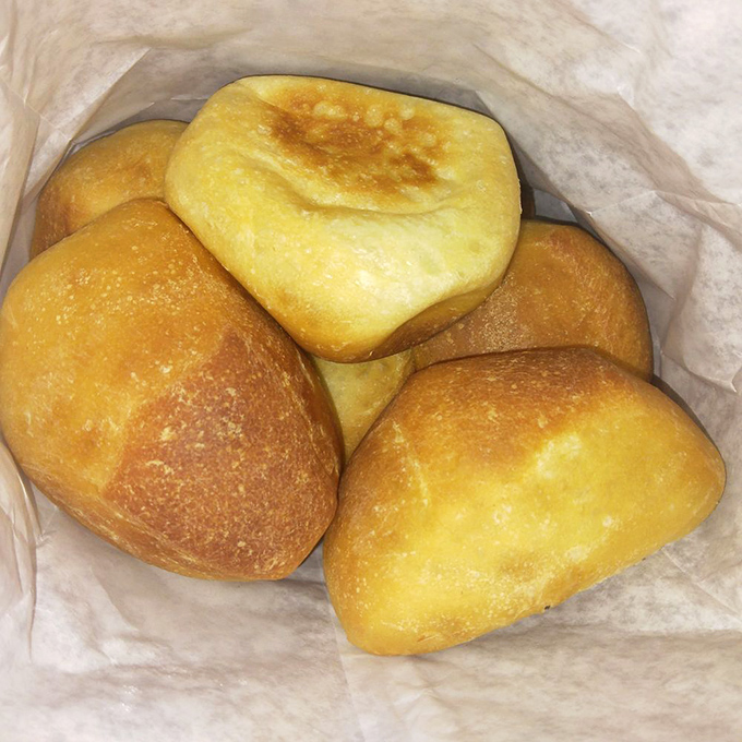 Pillowy dinner rolls nestled in their paper cradle &ndash; warm, yeasty perfection that somehow disappears before the main course even arrives.
