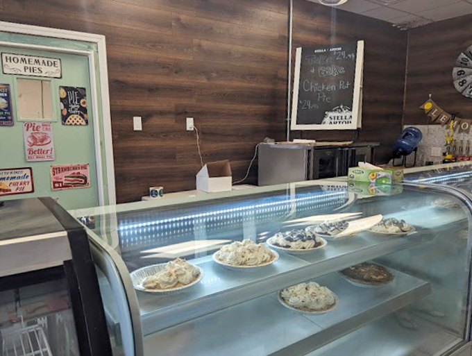 The curved display case showcases pies like museum pieces, though these masterpieces are meant to be devoured, not just admired.