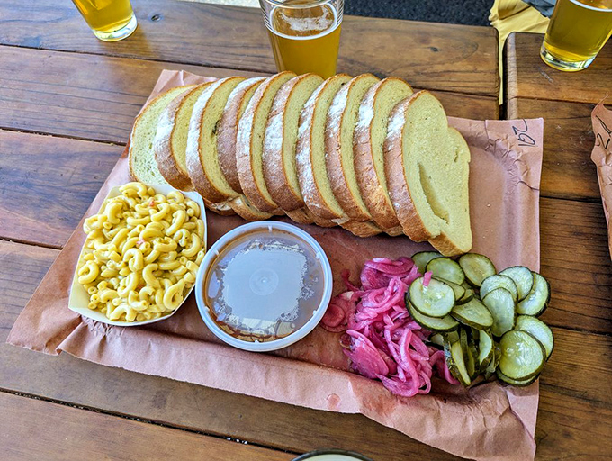 The bread board that makes you rethink your carb limits. Thick-cut potato bread, mac and cheese, and those essential pickled vegetables for cutting through the richness.