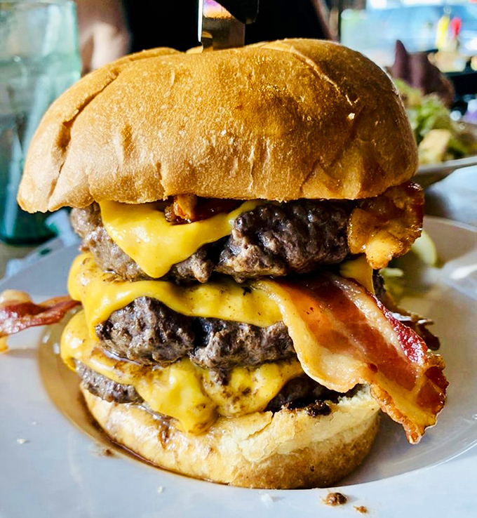 This towering bacon cheeseburger doesn't just satisfy hunger &ndash; it conquers it, plants a flag, and claims victory in the name of deliciousness.