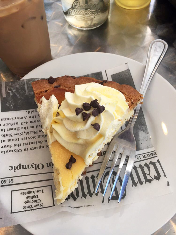 A slice of pie that's not just dessert but a spiritual experience, with whipped cream applied by someone who clearly understands the meaning of generosity.