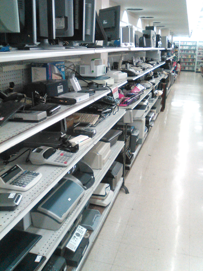 The electronics section—where retired technology finds new purpose and where someone's abandoned computer dream becomes your home office solution.