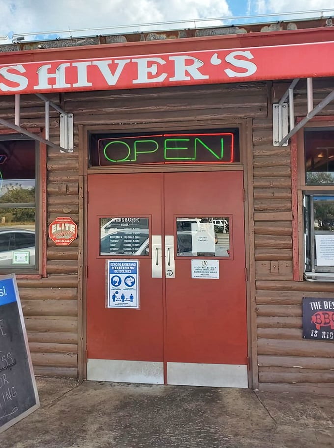 Those red doors might as well be pearly gates for barbecue enthusiasts. The neon "OPEN" sign is practically a religious symbol here.