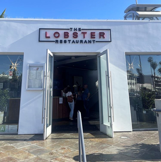 Sunshine bathes the entrance in golden California light, as if nature itself is providing a spotlight for your grand entrance to lobster paradise.
