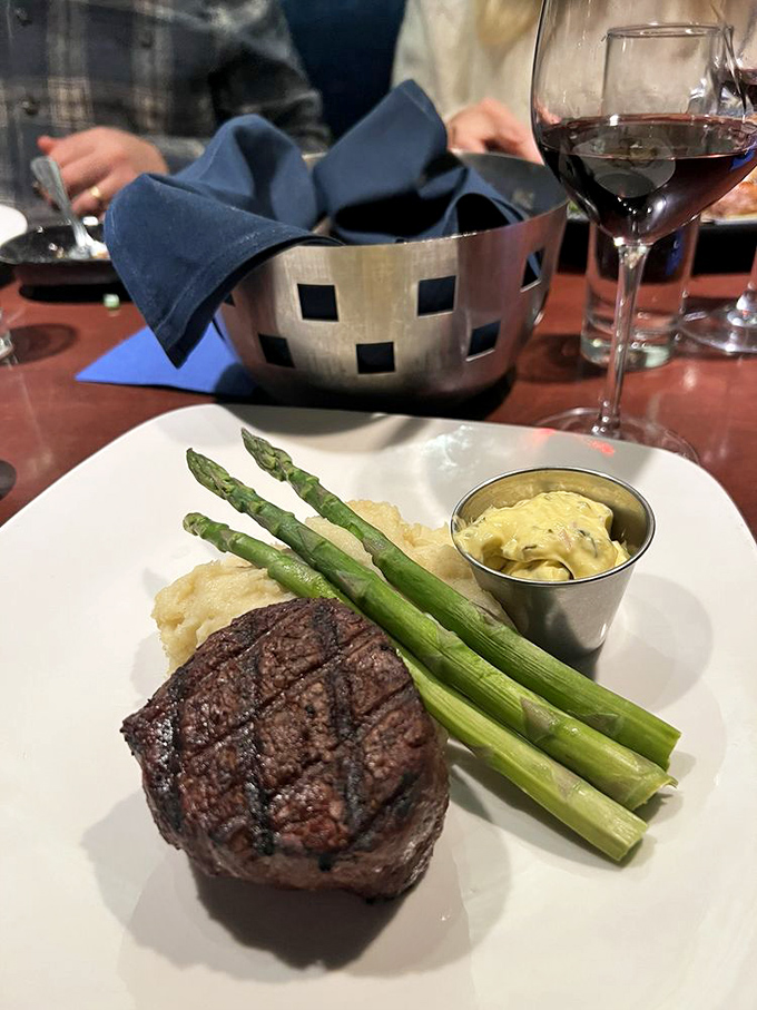 A perfectly seared filet with asparagus spears standing at attention. This isn't just steak&mdash;it's meat mathematics solved to perfection.