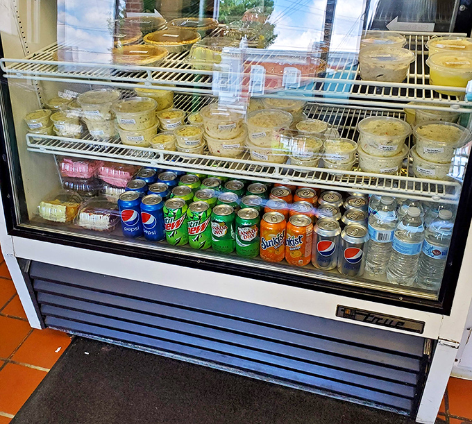 The refrigerated case offers sides and drinks, a supporting cast of characters for the star of the show&mdash;that legendary chicken.