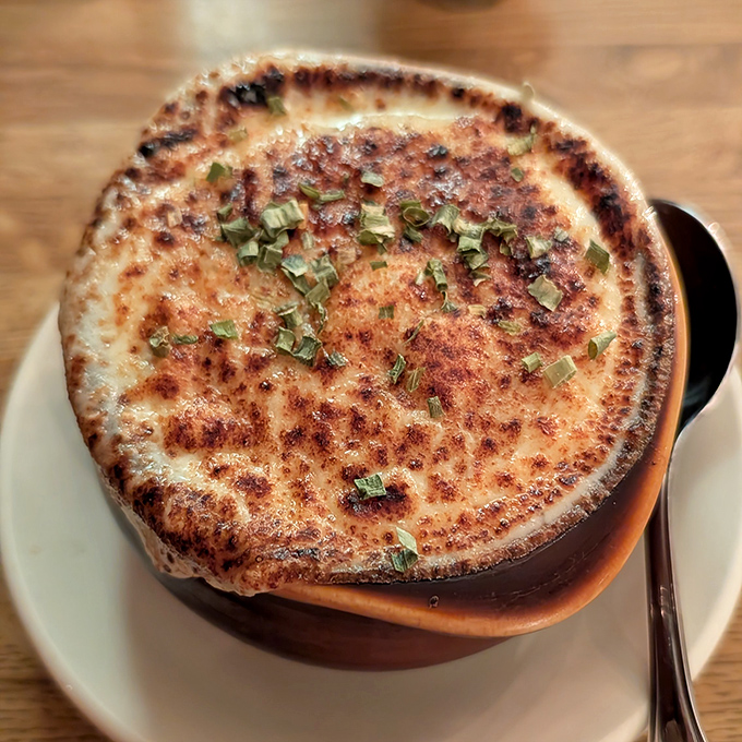 This isn't just French onion soup&mdash;it's a geological wonder with a molten cheese cap that stretches dramatically with each spoonful.