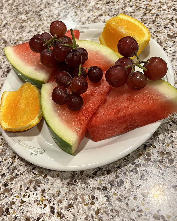 Fresh fruit offering a moment of virtuous eating before returning to the more decadent options waiting just steps away.