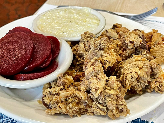 Fried chicken livers that could convert the skeptics, alongside pickled beets that pop with color and grits smoother than a jazz saxophone.