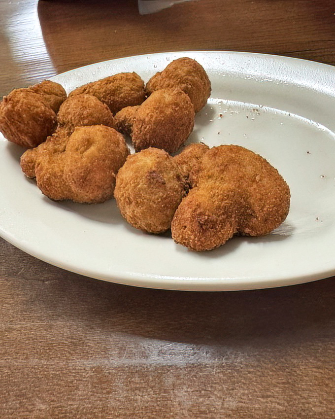 Fried mushrooms that achieve the perfect crisp-to-tender ratio. These little golden bombs of flavor aren't trendy—they're timeless for good reason.