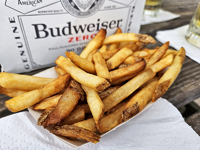 French fries that achieve the golden ratio of crispy exterior to fluffy interior—the kind that make you protective of your plate.
