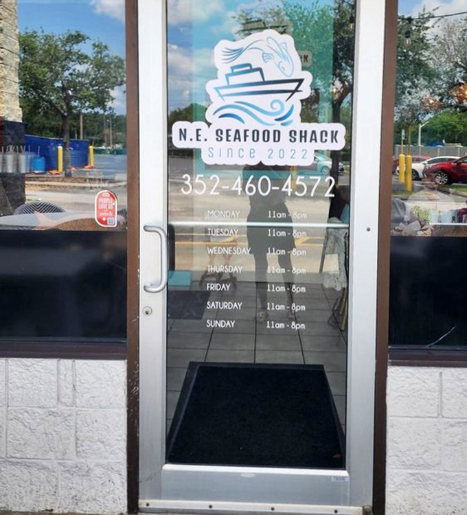 The entrance to seafood paradise, complete with hours for planning your next visit. This isn't just a door—it's a portal to a world where calories don't count.