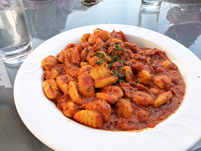 This gnocchi doesn't just sit in sauce—it performs synchronized swimming routines in a tomato pool that demands to be sopped up.