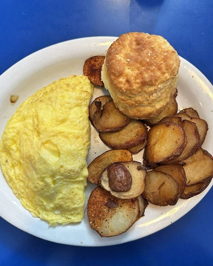 The perfect omelet doesn't exi— Oh wait, here it is. That biscuit isn't just a side—it's the supporting actor deserving its own award.