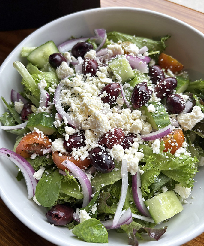 A Greek salad that actually tastes like sunshine—crisp vegetables, briny olives, and crumbled feta create a Mediterranean vacation on a plate.