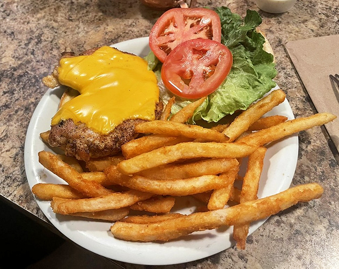 A cheeseburger that reminds you sometimes land-based options at seafood joints deserve attention too. That melty cheese is making a compelling argument.