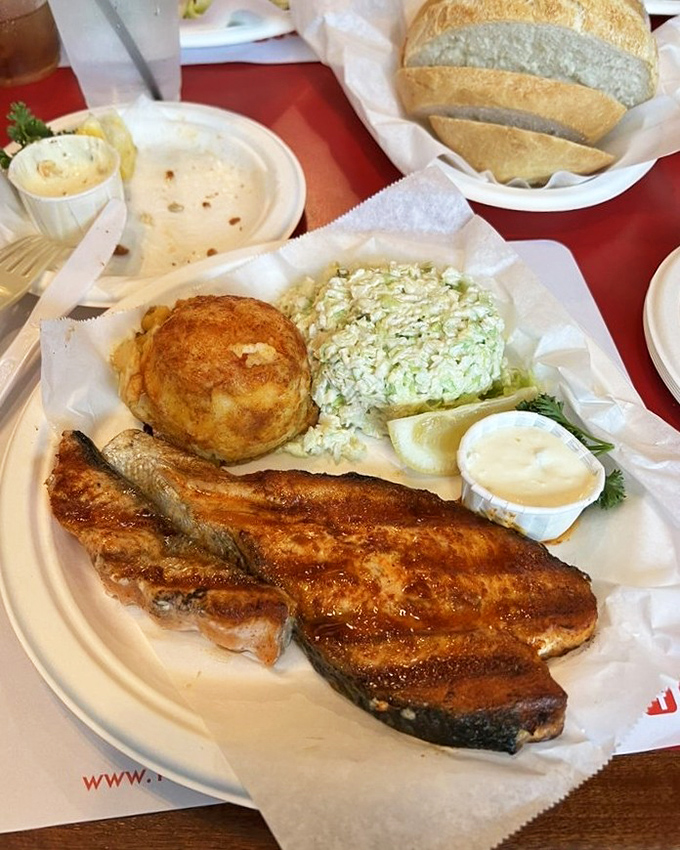 A perfectly grilled salmon dinner on a paper plate proves once again that presentation matters far less than what hits your taste buds.
