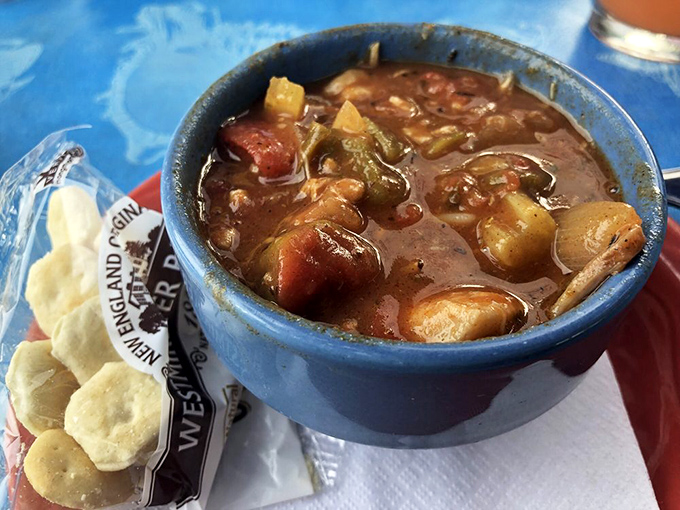 A blue bowl of coastal comfort. This hearty gumbo, packed with seafood and vegetables, tells delicious stories of Gulf traditions in every steaming spoonful.