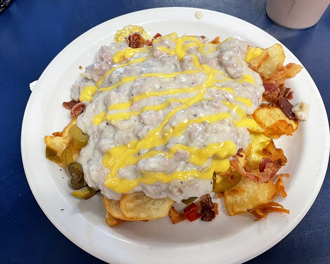 The "Haystack"&mdash;where breakfast meets architectural ambition. A foundation of potatoes crowned with country gravy and a sunshine drizzle of cheese.