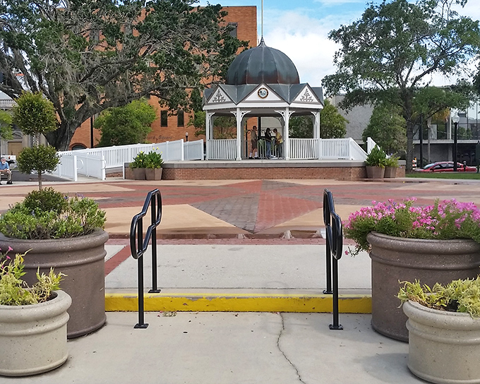 The iconic gazebo in Ocala's town square stands like a Victorian-era time machine amid brick pathways and carefully tended flowers.