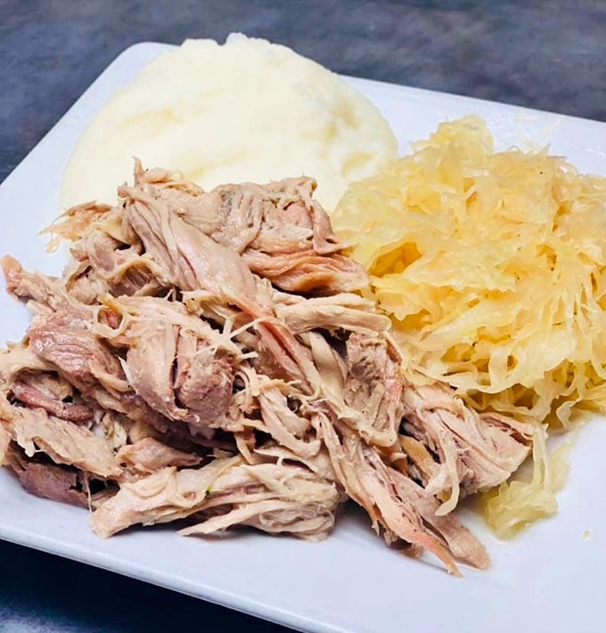Pulled pork alongside tangy sauerkraut and creamy mashed potatoes. A Pennsylvania Dutch classic that proves some traditions are worth preserving.