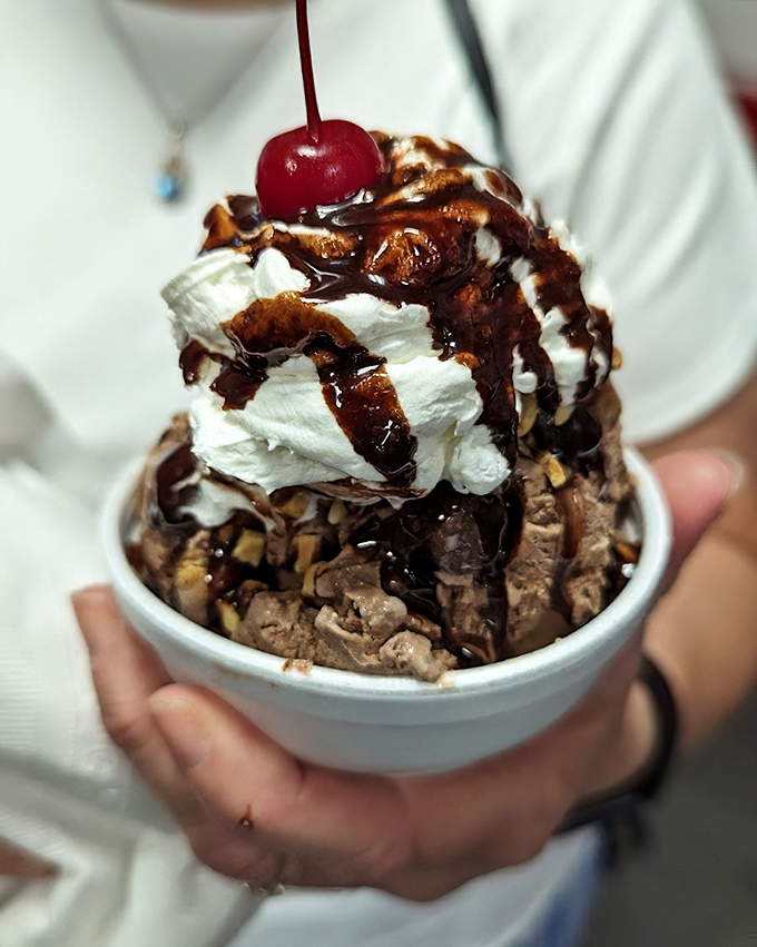 Hot fudge cascading over cold ice cream&mdash;proof that opposites don't just attract, they create moments of pure bliss topped with a cherry.