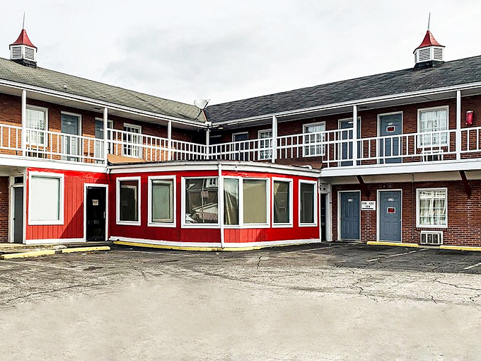 This classic motor lodge with its distinctive red accent wall offers a nostalgic nod to mid-century road trips and simpler times.