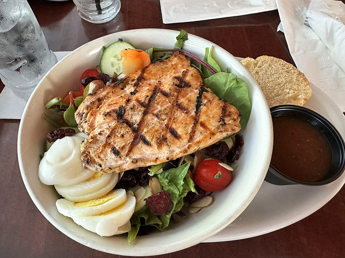 A salad that doesn't apologize for being healthy because it's crowned with salmon that makes vegetables worth eating.