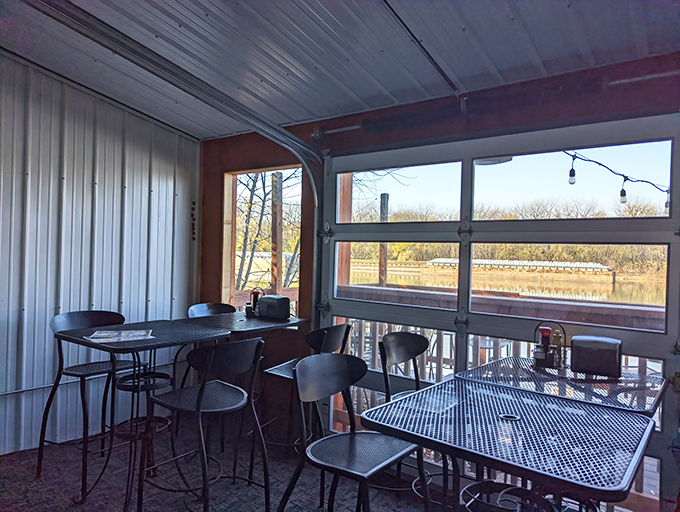 The riverside dining room offers panoramic water views through garage-style doors&mdash;bringing the outside in and making every table feel like the best seat in the house.