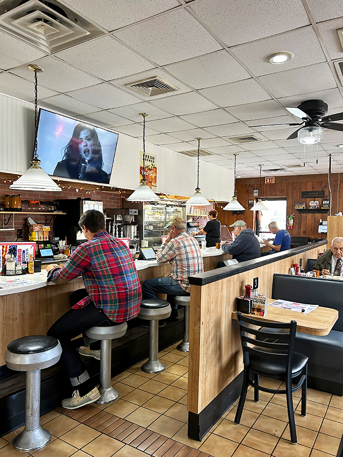 Classic diner counter culture in full swing – where strangers become friends over coffee refills and shared appreciation for homestyle cooking.