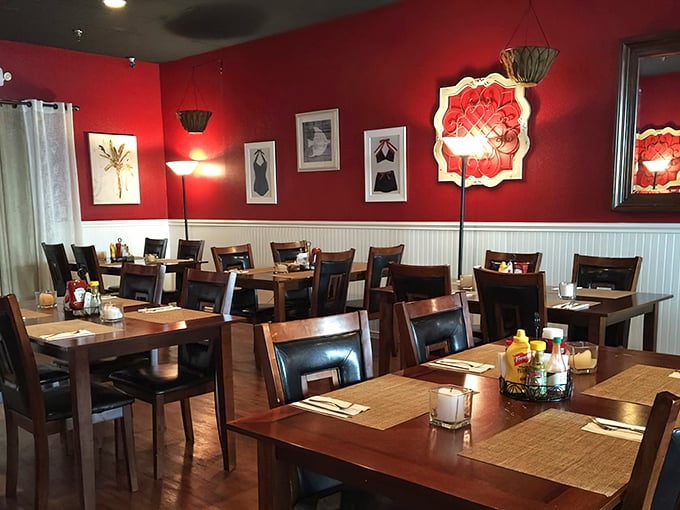 The dining room's bold red walls and elegant lighting transform dinner into an occasion, even when you're just wearing Tuesday's casual best.