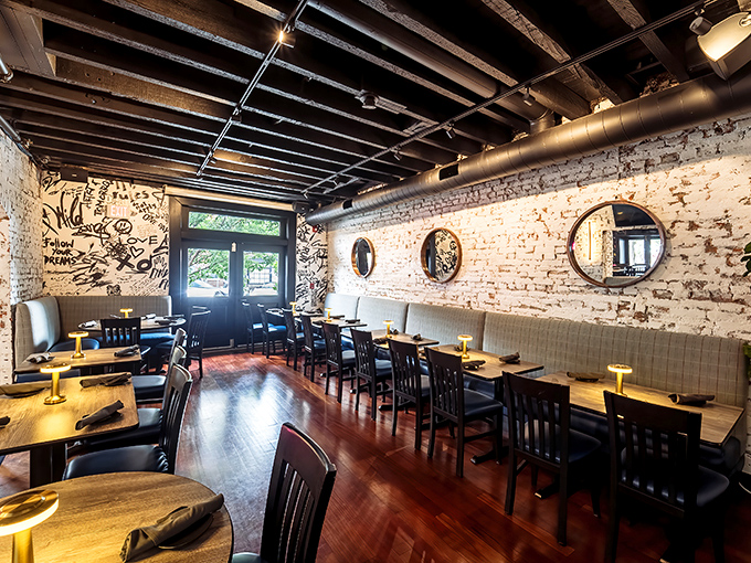 Exposed brick walls tell stories while wooden tables await yours. This dining room doesn't just serve food&mdash;it hosts moments.