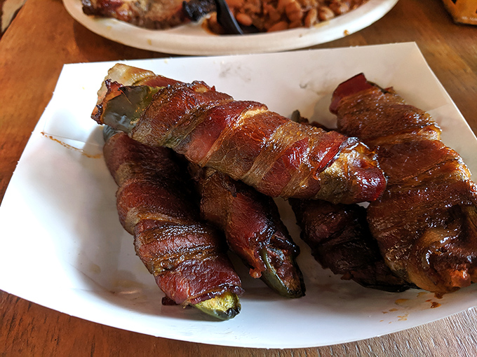 These aren't just jalape&ntilde;o poppers&mdash;they're smoke-kissed flavor bombs wrapped in bacon, proving that vegetables can be delicious when properly corrupted.