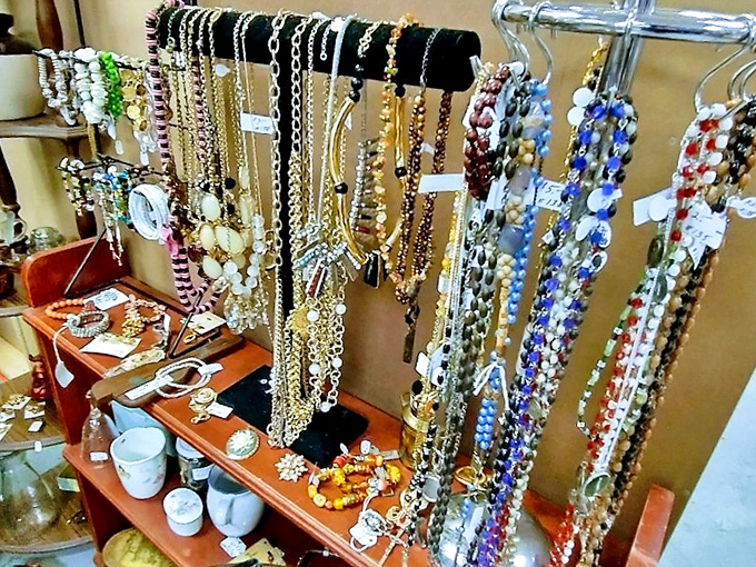 A dazzling display of vintage costume jewelry dangles with possibility. Each necklace carries stories from proms, weddings, and Saturday nights past.