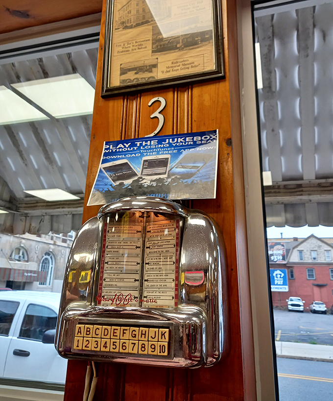 A tabletop jukebox that remembers when music cost a quarter and came with a side of mechanical satisfaction. No playlists, just choices.