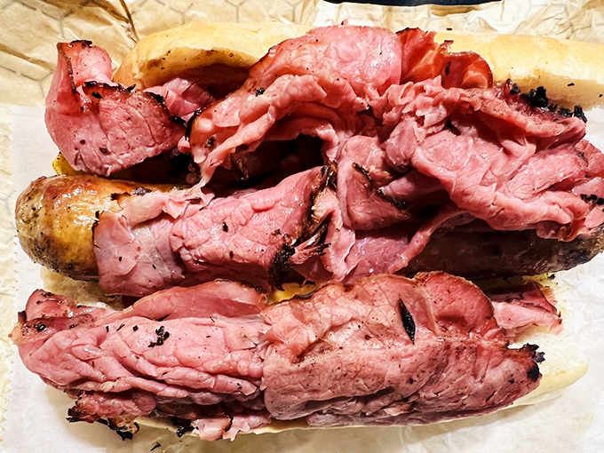 This isn't just a sandwich—it's a structural engineering feat. The rosy layers of pit ham practically glow with smoky promise.