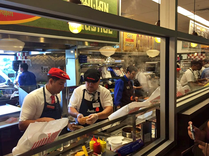 Open kitchen magic happens here, where skilled hands craft each sandwich with visible pride and precision.